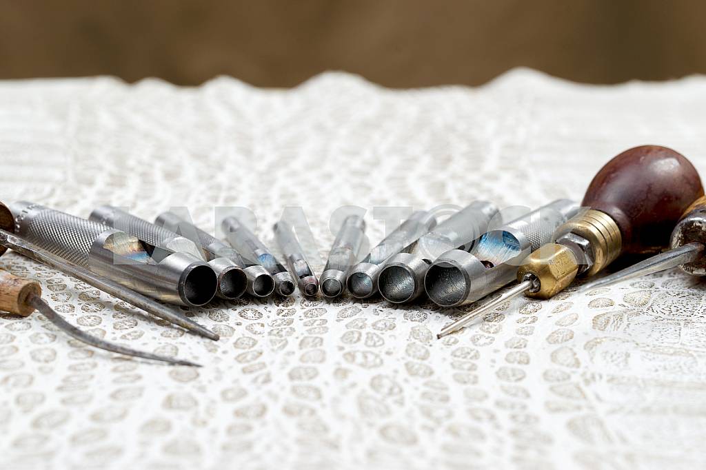 Leather craft tools on a leather background. Craftsman work desk ...